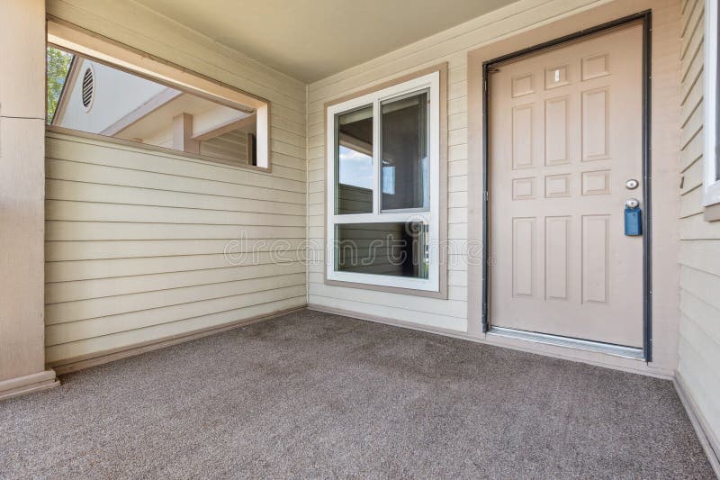 An Empty Porch Featuring a Door Along with a Window in a House Stock ...