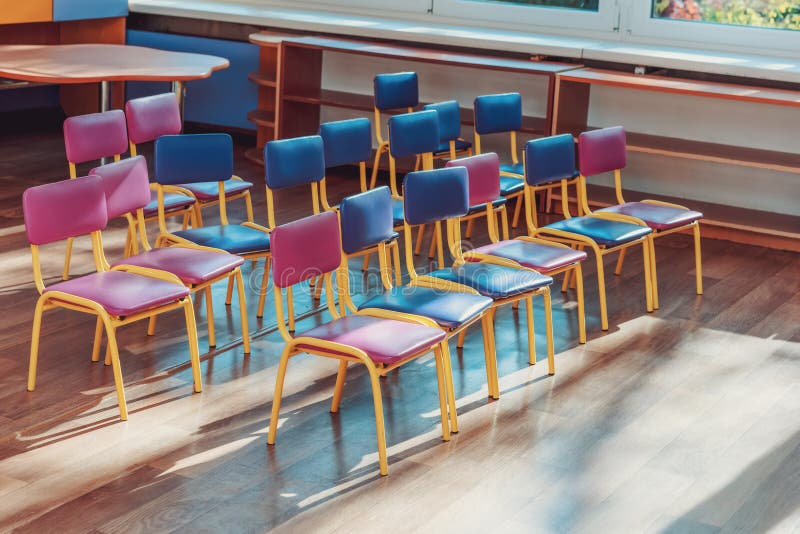 Empty Preschool Classroom with Multi Colored Chairs Standing in Rows ...