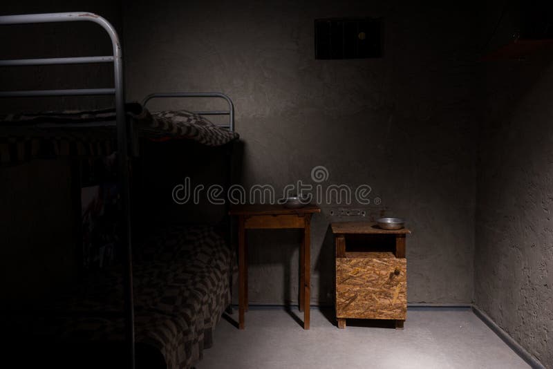 An Empty Prison Cell with Bunk Bed and Bedside Table Stock Photo ...
