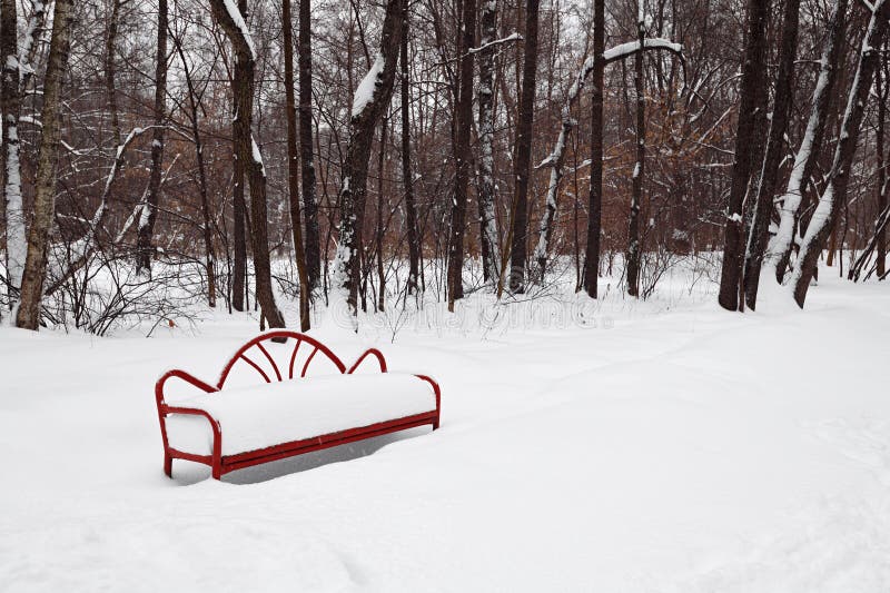 Empty Red Bench Covered with Snow in a Winter City Park Stock Image ...