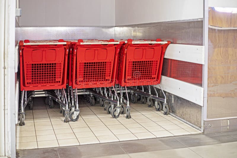 Empty Red Shopping Carts in a Supermarket Stacked One Inside Stock ...