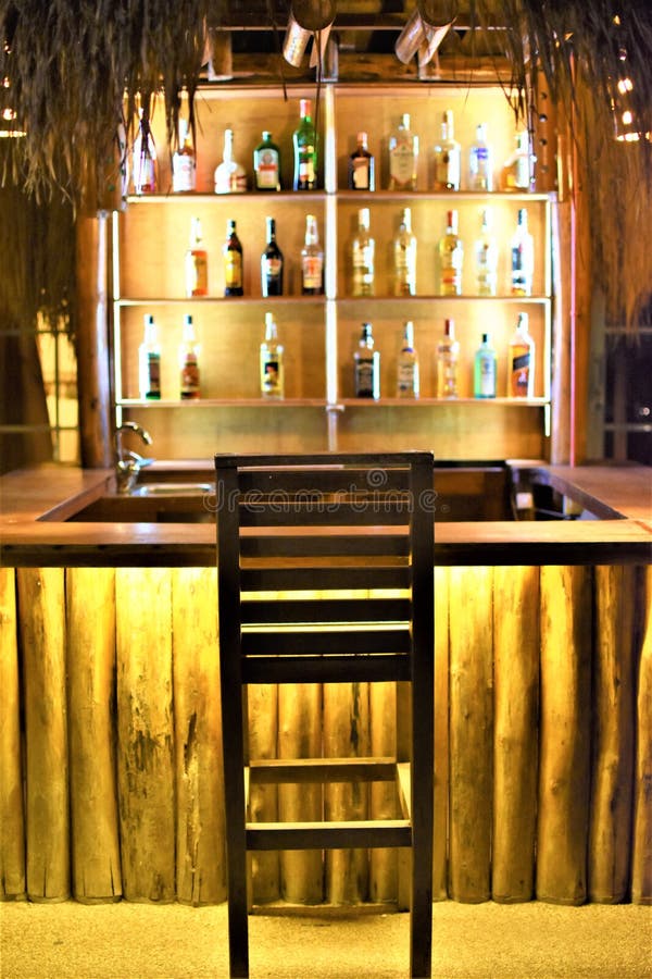 An Empty Resort Bar with a Lone Stool Stock Photo - Image of bottle ...
