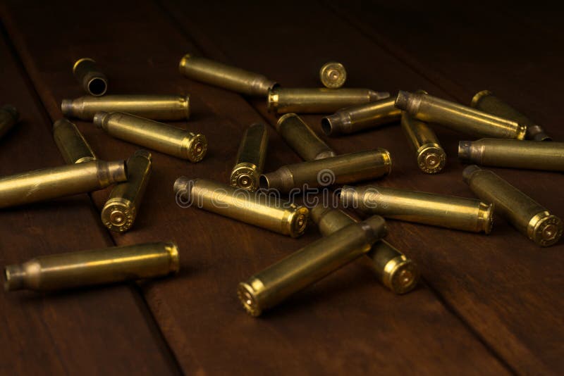 Empty Rifle Shells on Dark Wooden Board Stock Photo - Image of empty ...