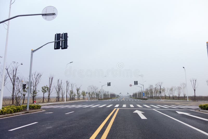 Empty Road with Traffic Lights and Crosswalks Against the Background of ...