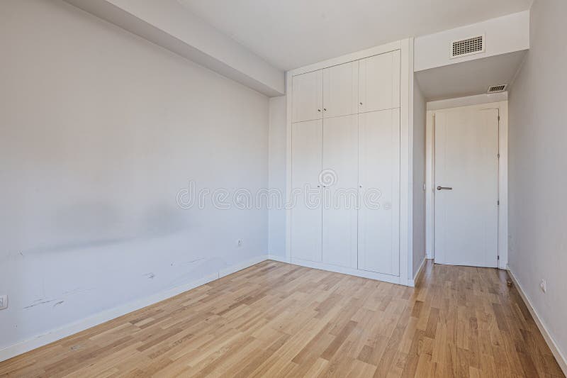Empty Room with Blue Walls, a Three-section Built-in Wardrobe with ...