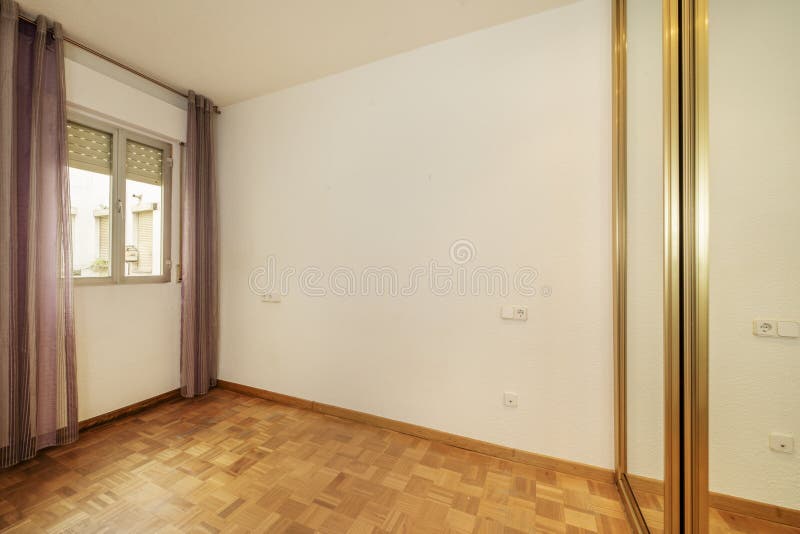 Empty Room with Built-in Wardrobe with Gold Foil Edged Mirror Doors and ...
