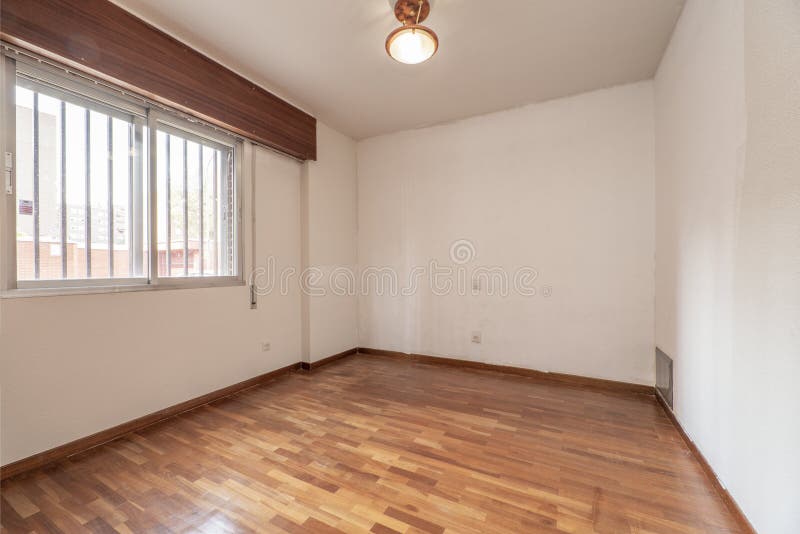 Empty Room with Reddish Parquet Flooring, Plain White Painted Walls and ...