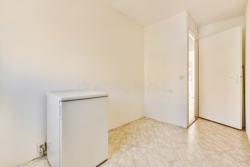 An Empty Room with a Refrigerator in it Stock Image - Image of lamp ...