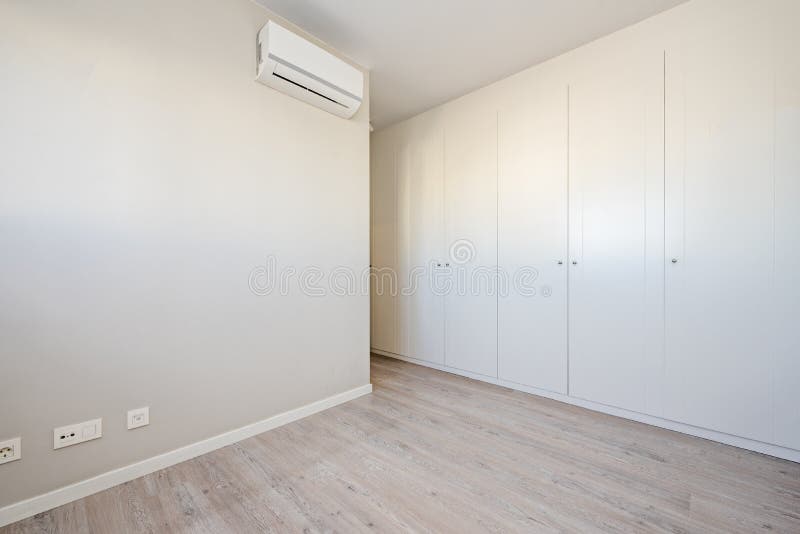 Empty Room with a Wall Full of Fitted Wardrobes Stock Image - Image of ...