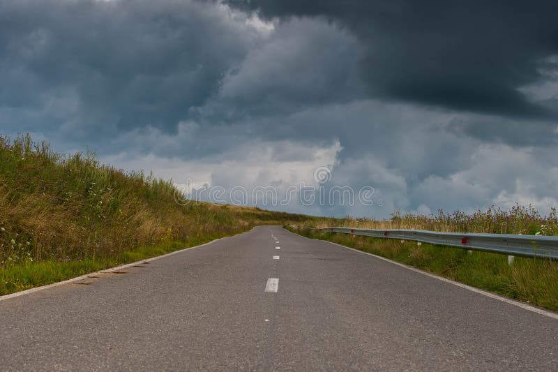 Empty Rural Asphalt Road with Green Vegetation, Dark Dramatic Gathering ...