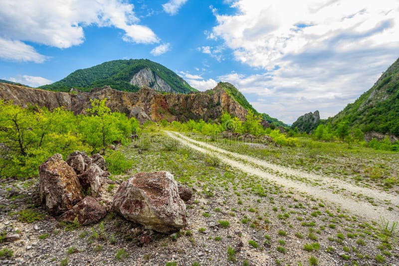 Road through Rugged Terrain Stock Photo - Image of outdoors, sandstone ...
