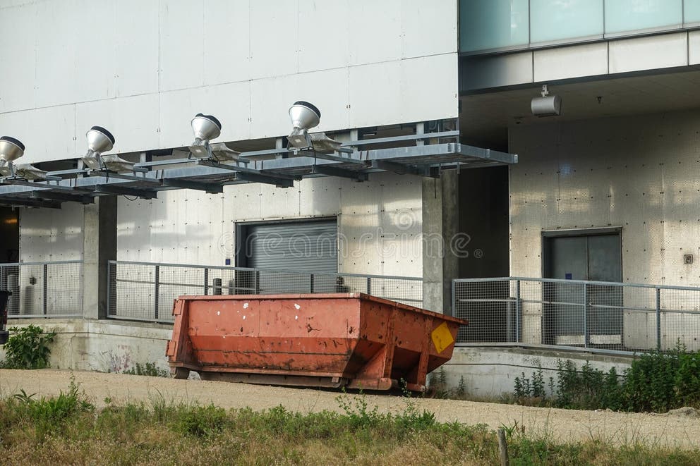 Empty Rust Colored Dumpster Behind a Large Building Stock Image - Image ...