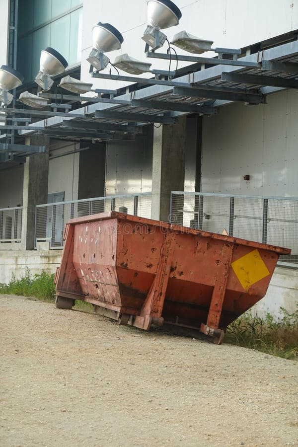 Empty Rust Colored Dumpster Behind a Large Building Stock Photo - Image ...