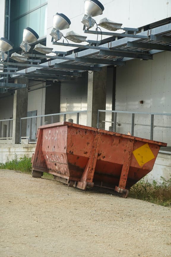 Empty Rust Colored Dumpster Behind a Large Building Stock Photo - Image ...