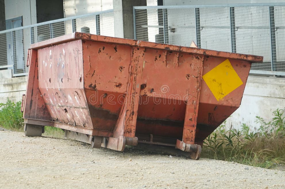 Empty Rust Colored Dumpster Behind a Large Building Stock Photo - Image ...