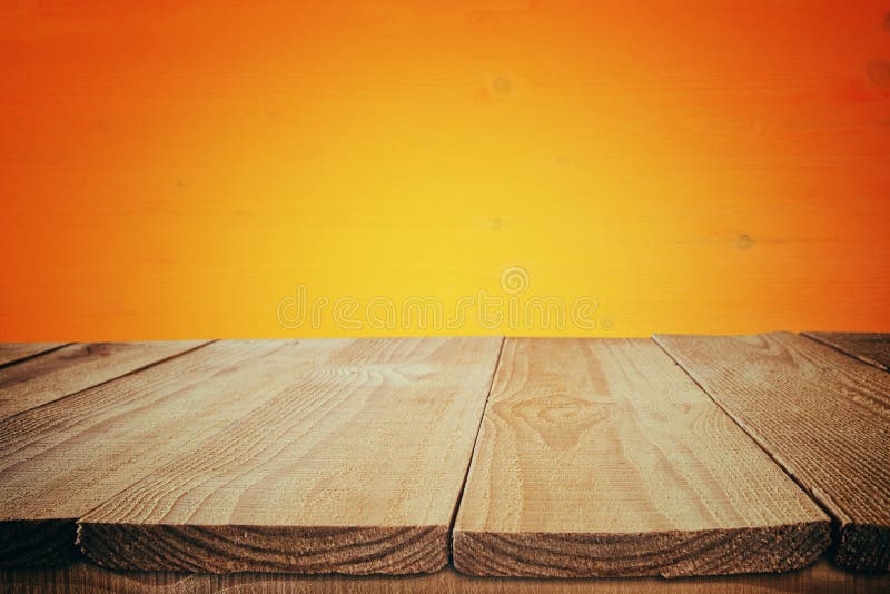Empty Rustic Table in Front of Orange Background Stock Photo - Image of ...