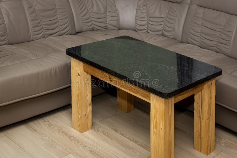 Empty Rustic Table Made of Polished Granite by a Soft Leather Sofa ...
