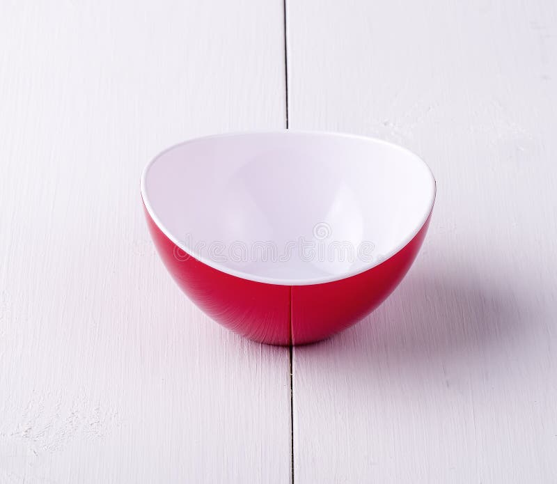 An Empty Red Salad Bowl and Three Cups on a White Wooden Table Stock ...