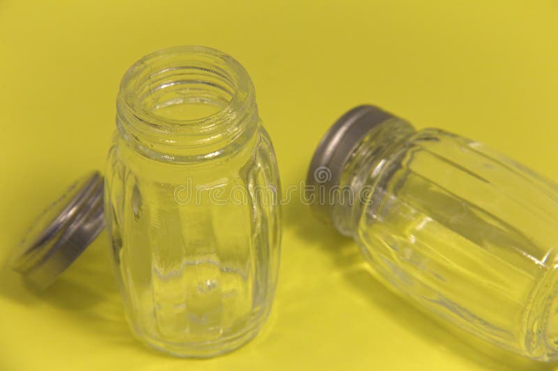 Empty Salt Shakers. on a Yellow Background Stock Image - Image of glass ...