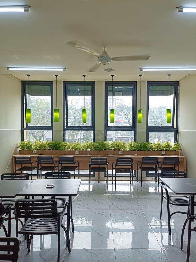 Empty Seating with Tables and a Ceiling Fan with a View Out the Window ...
