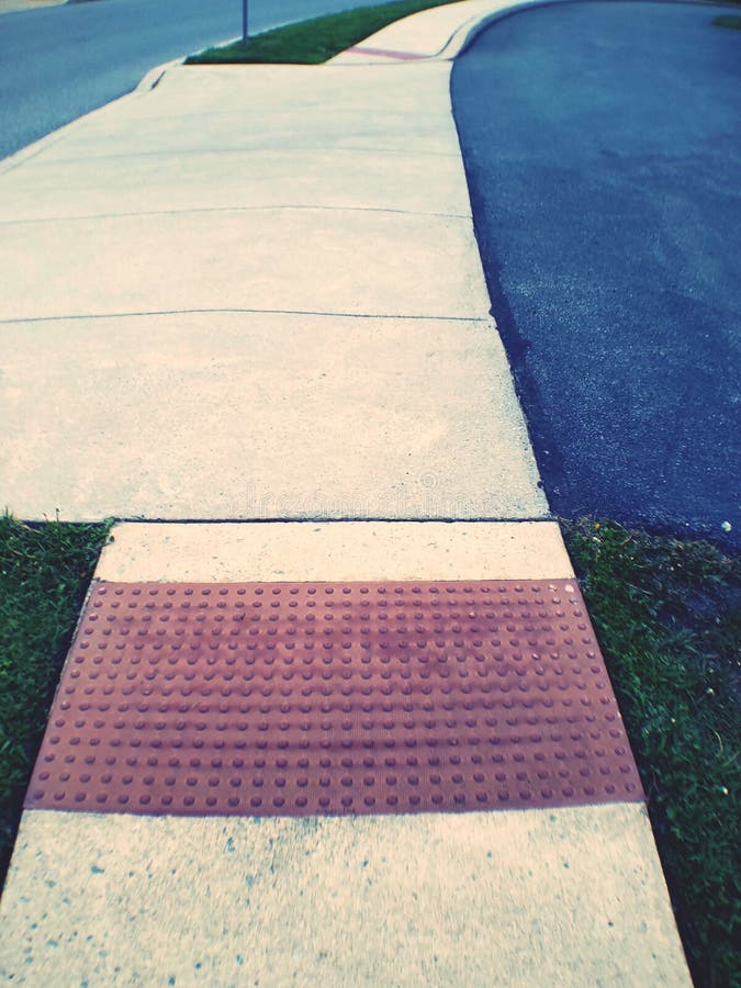 A Empty Sidewalk with Red Bumpy Steps Crossing a Empty Road Stock Photo ...