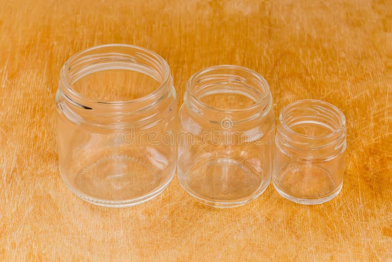 Empty Small Glass Jars Different Sizes on a Wooden Surface Stock Photo ...