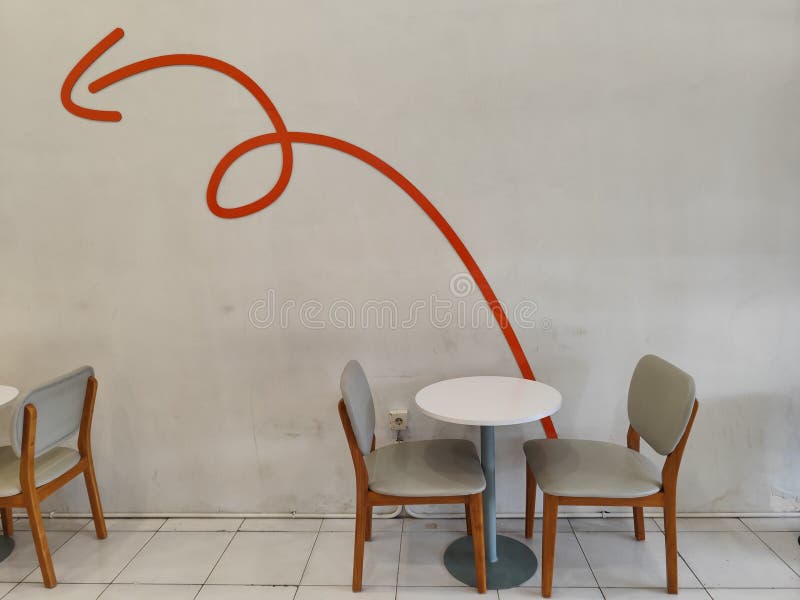 Empty Small Round Table with Two Chairs Against a Plain Wall. Simple ...