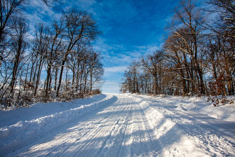 Empty snow covered road stock image. Image of scene - 163042145