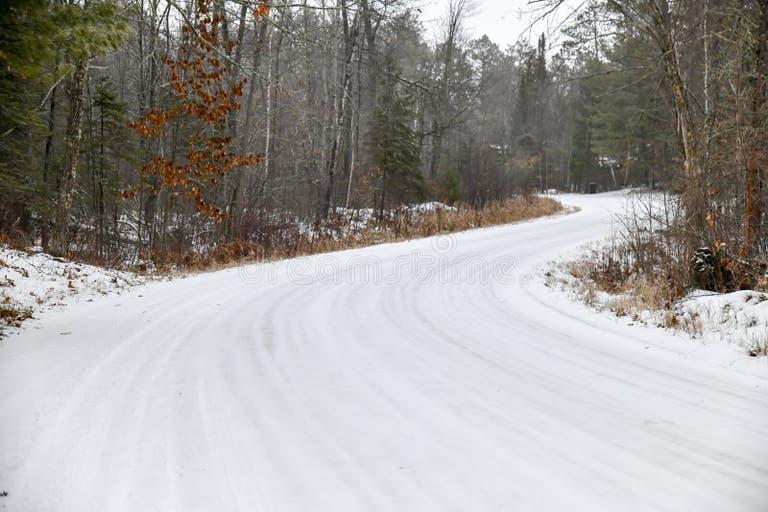 Empty Snowy Road in Minnesota Winter through the Forest Trees Stock ...
