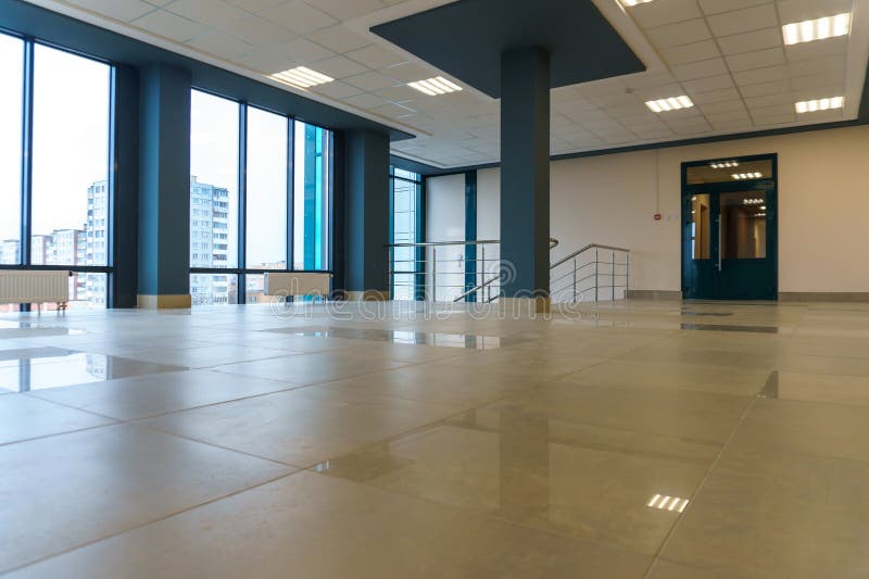 An Empty Spacious Room of a Modern Office Building with Large Windows ...