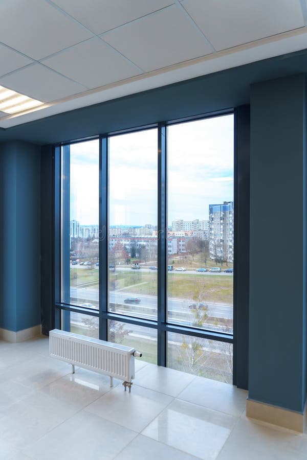 An Empty Spacious Room of a Modern Office Building with Large Windows ...