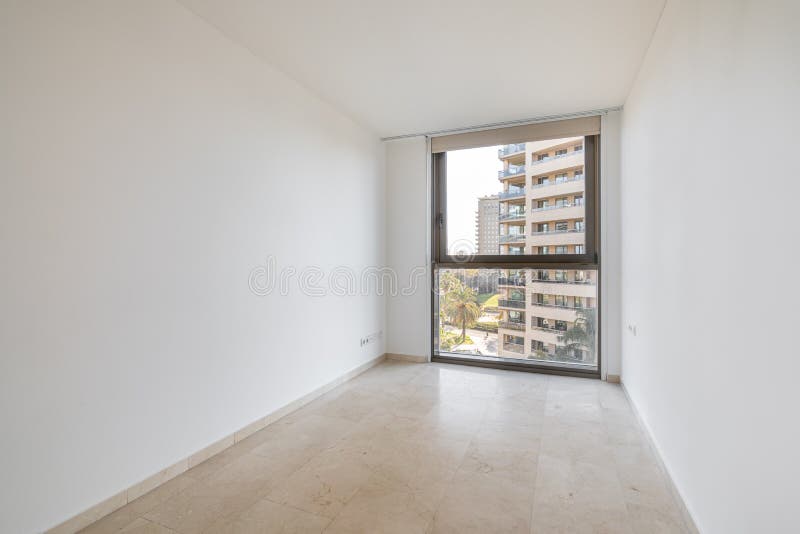 An Empty Spacious White Square Room with a Large Floor-to-ceiling Brown ...