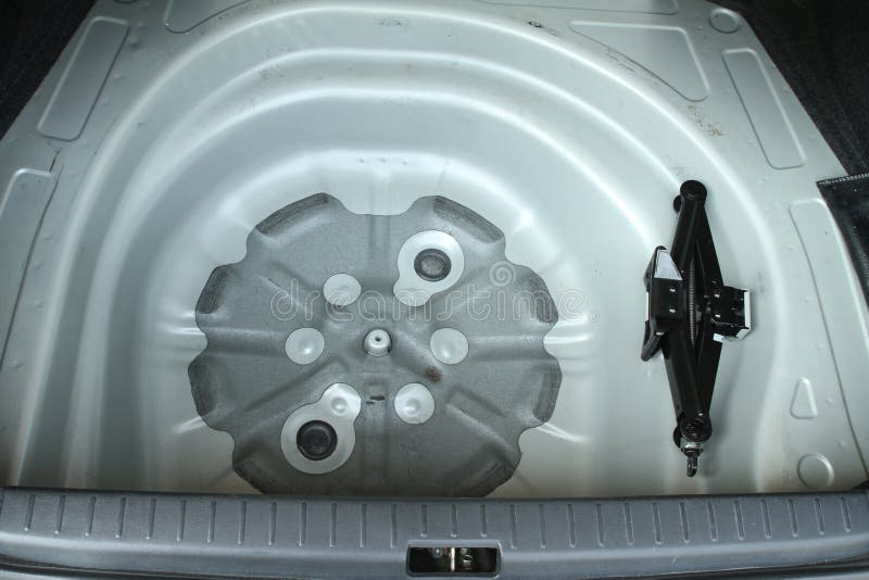 Spare wheel in storage bin stock photo. Image of vehicle - 137036804