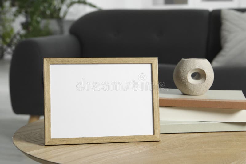 Empty Square Frame and Books on Coffee Table Indoors Stock Image ...