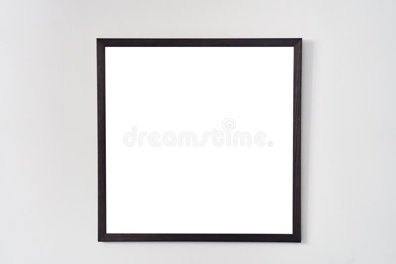 An Empty Square Photo Frame with a Black Border Hanging on a White Wall ...