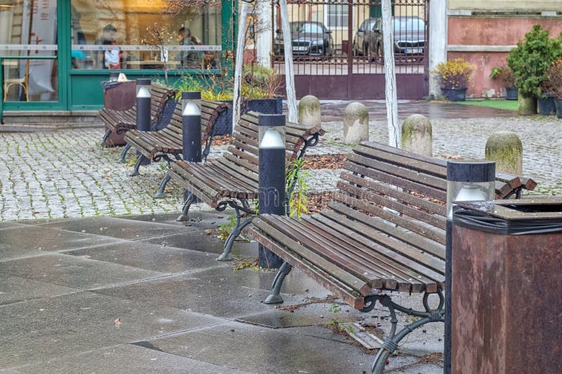 .an Empty Square with Several Wooden Benches Lined Up Along a Paved ...