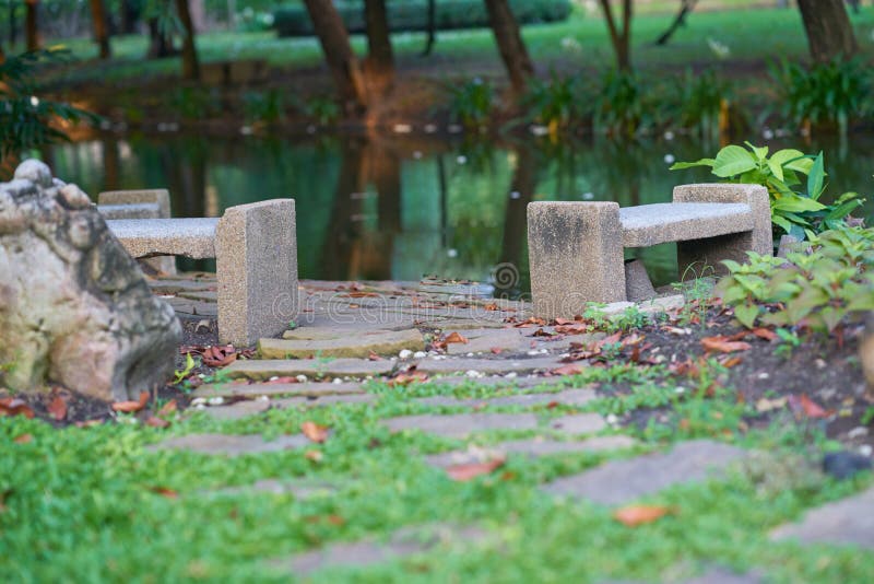 Empty Stone or Cement Benches on Blur Water Pond in Garden Background ...