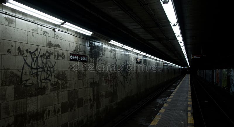 Empty Subway Platform with Graffiti and Fluorescent Lighting Stock ...