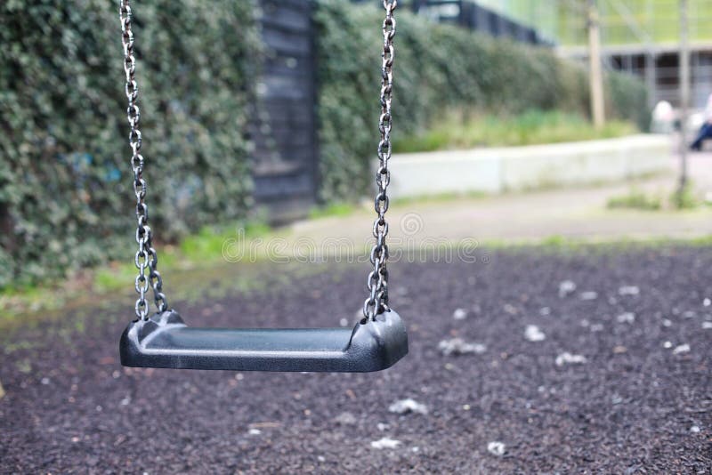 Empty Swing with Chains on the Playground Stock Photo - Image of ...