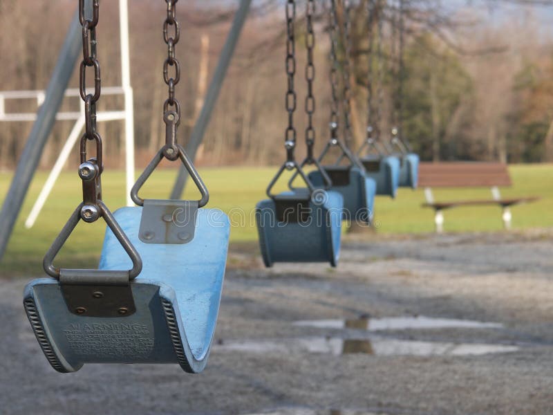 Empty swings stock photo. Image of puddle, swingset, childhood - 1882776