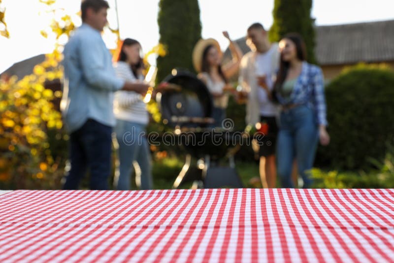Empty Table and Blurred View of Friends Having Barbecue Party Outdoors ...