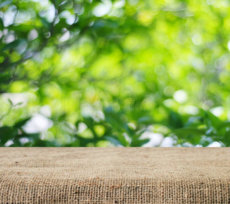 Empty Table Covered with Sackcloth Over Blurred Trees with Bokeh ...