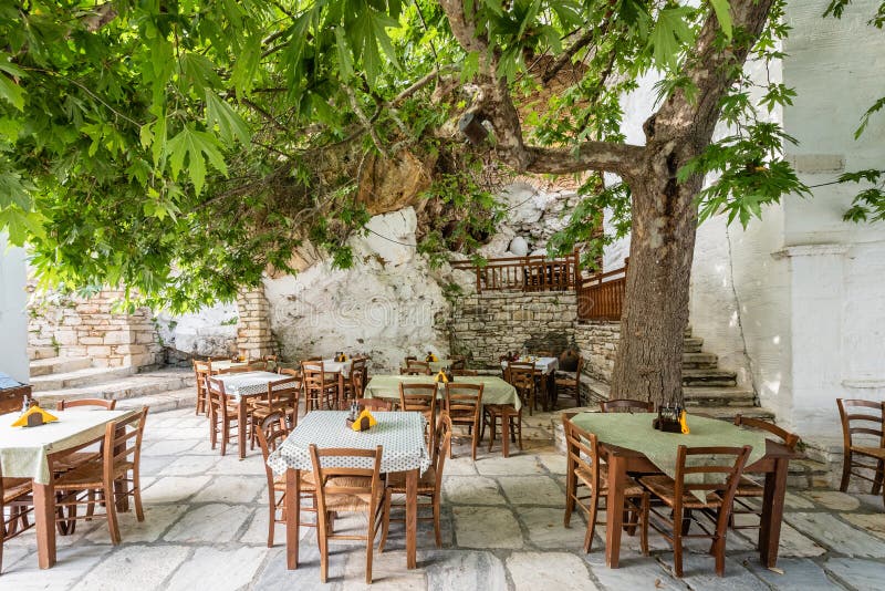 Restaurant Terrace in a Picturesque Square, with Empty Tables Under a ...