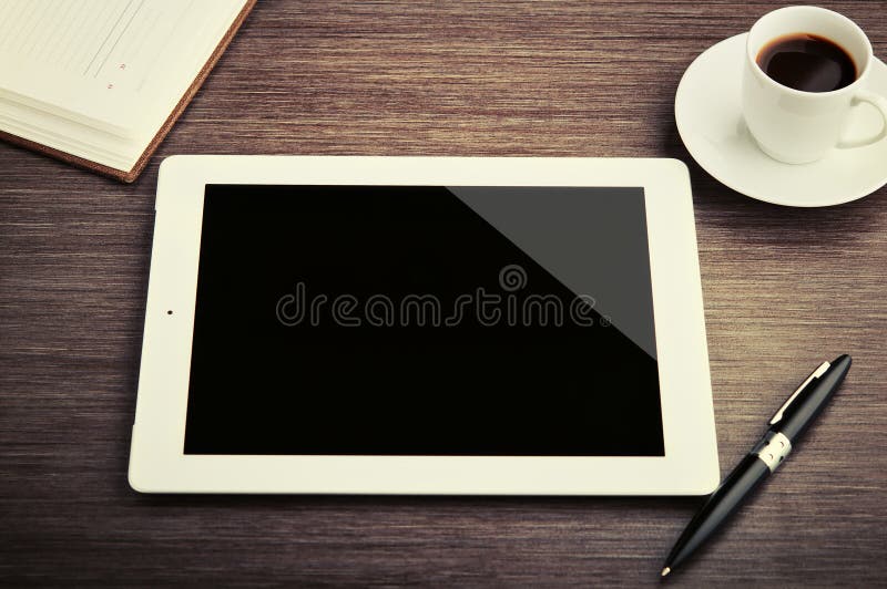 Tablet Pc and a Coffee and Notebook with Pen on the Office Desk Stock ...