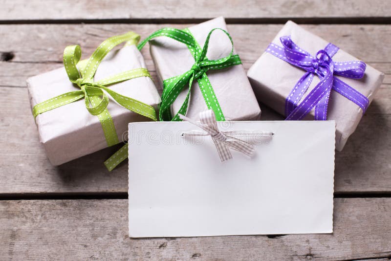 Empty Tag and Three Festive Gift Boxes with Presents on Vintage Stock ...