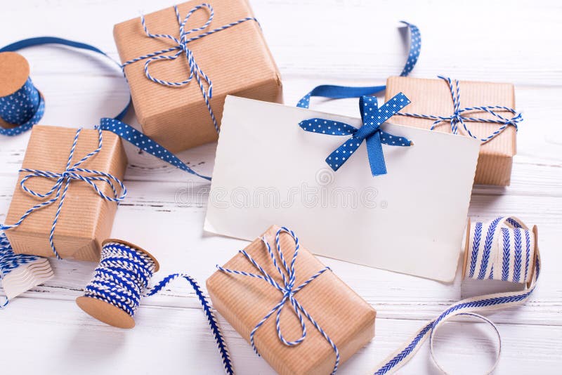 Empty Tag and Wrapped Gift Boxes with Presents and Blue Ribbo Stock ...