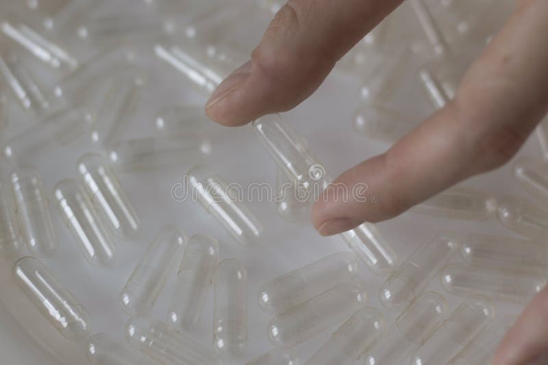 Empty Transparent Capsules in Hand on White Background. Stock Photo ...