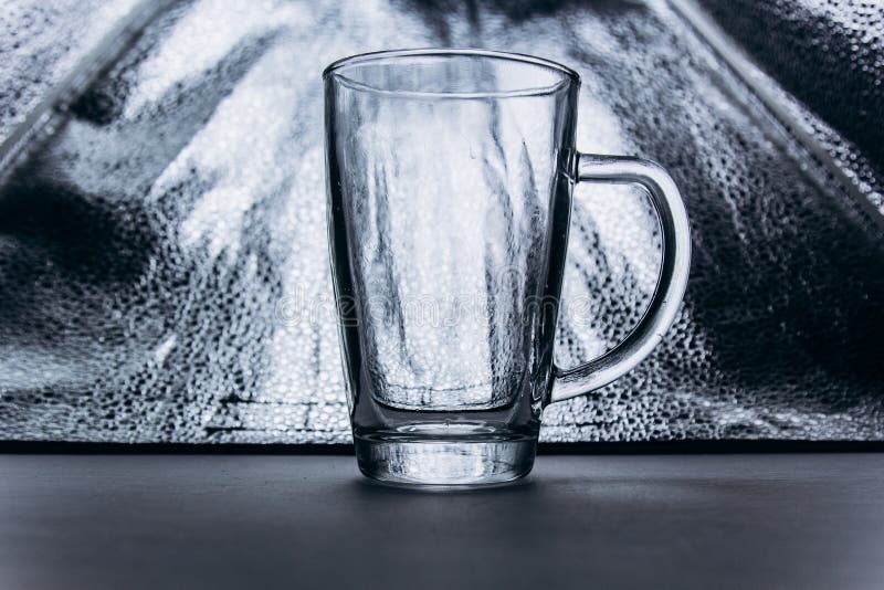 Empty Transparent Glass Cup on a Gray Silver Background Close-up. High ...