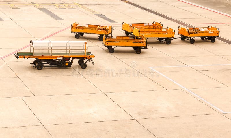 Empty Transporting Baggage Trailer To Airplane on Runway. Stock Image ...
