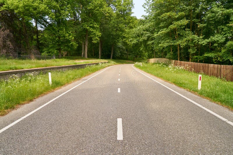 Empty Two Lane Road Through Green Landscape Stock Photo - Image of trip ...